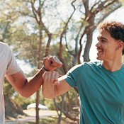 Running, fist bump and men in forest, fitness and training with support ...