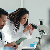 Microscope, team and research with people in laboratory for science ...