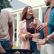 BBQ, conversation and laughing with friends in backyard of home ...
