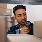 Man, scanner and boxes barcode at warehouse for inspection, stock and ...