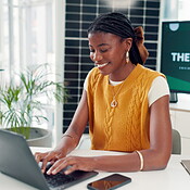 Woman, typing and research in office with laptop, sustainability report ...